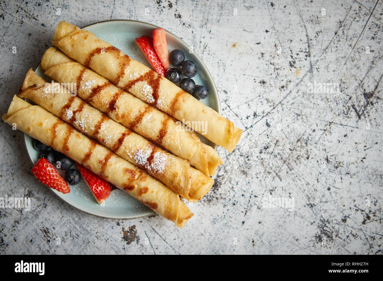 Plate of delicious crepes roll with fresh fruits and chocolate Stock ...
