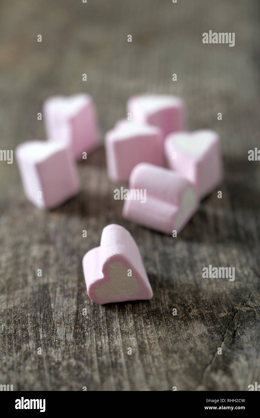heart-shaped marshmallows on wooden surface Stock Photo - Alamy
