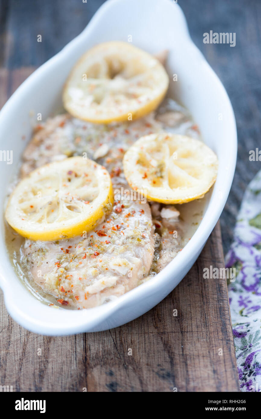 Baked fish fillet in butter and lemon sauce Stock Photo - Alamy