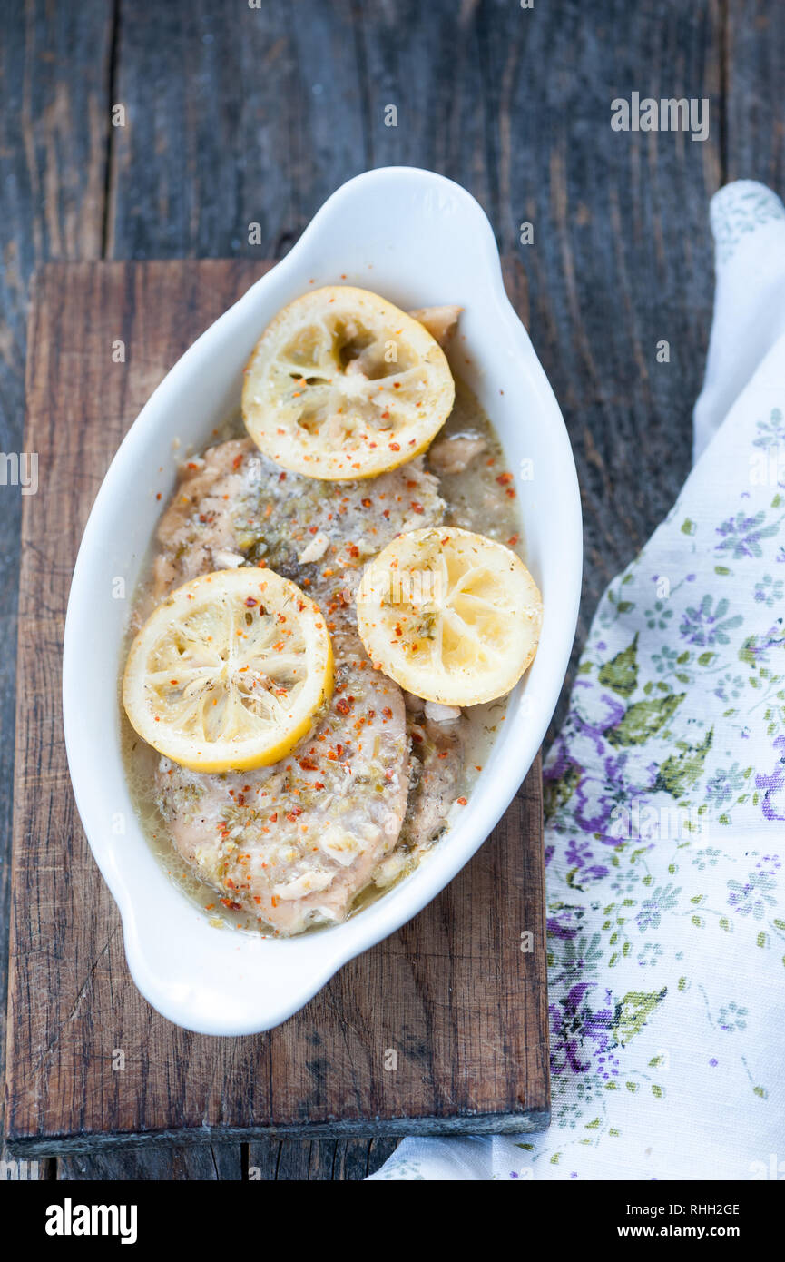 Baked fish fillet in butter and lemon sauce Stock Photo - Alamy