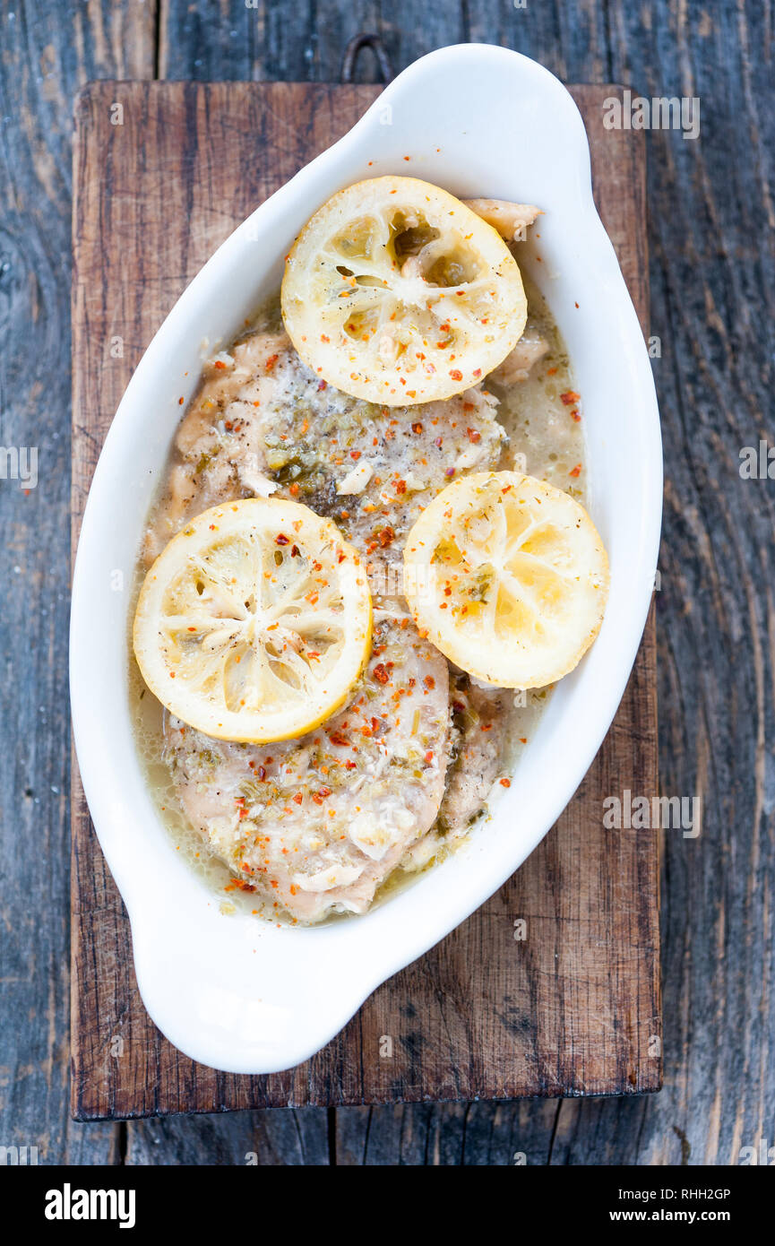Baked fish fillet in butter and lemon sauce Stock Photo - Alamy