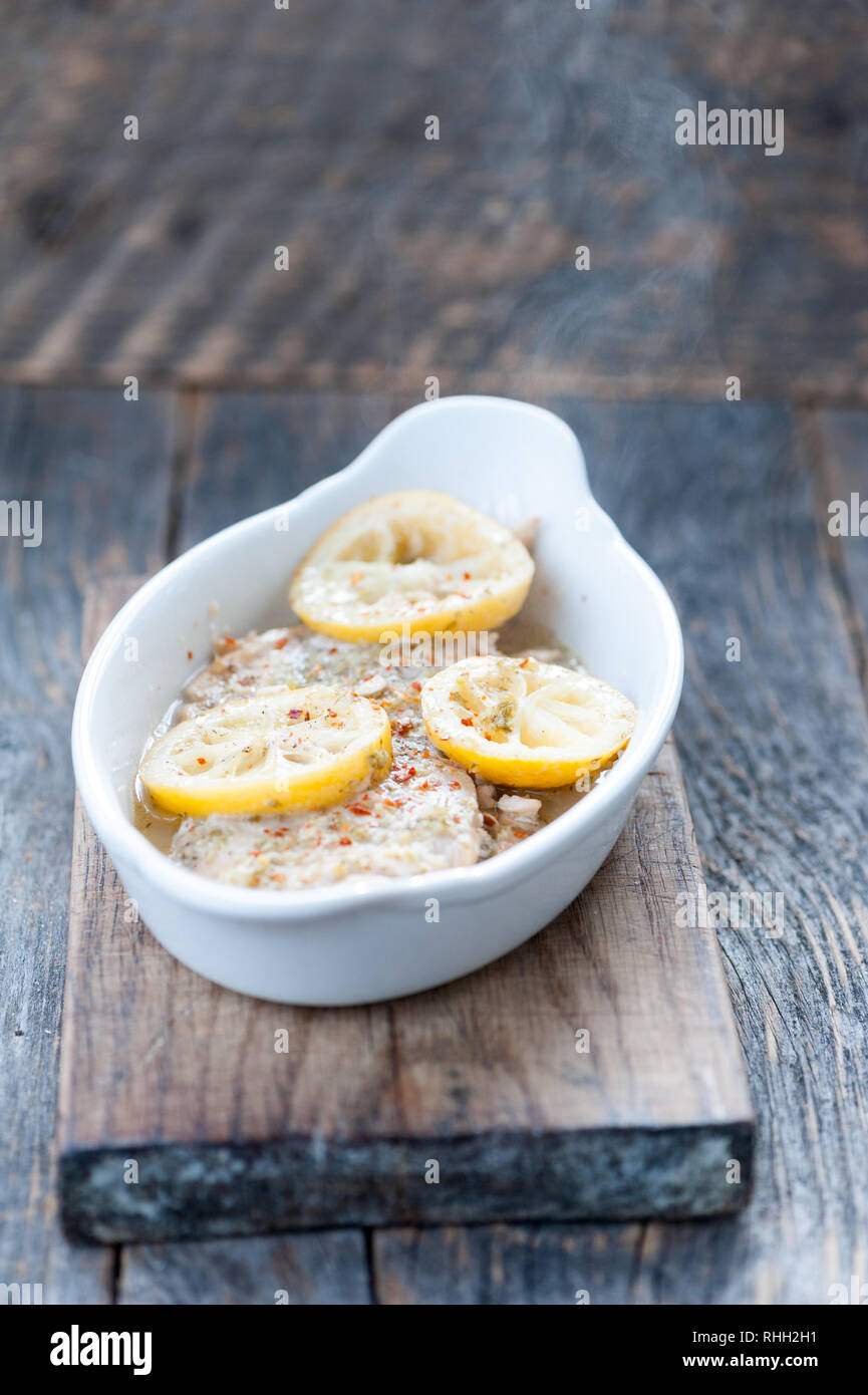 Baked fish fillet in butter and lemon sauce Stock Photo - Alamy