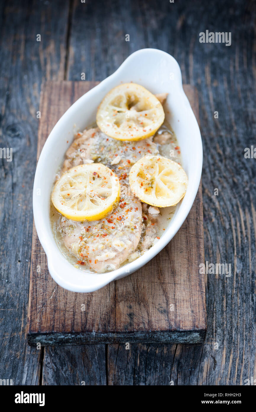 Baked fish fillet in butter and lemon sauce Stock Photo - Alamy