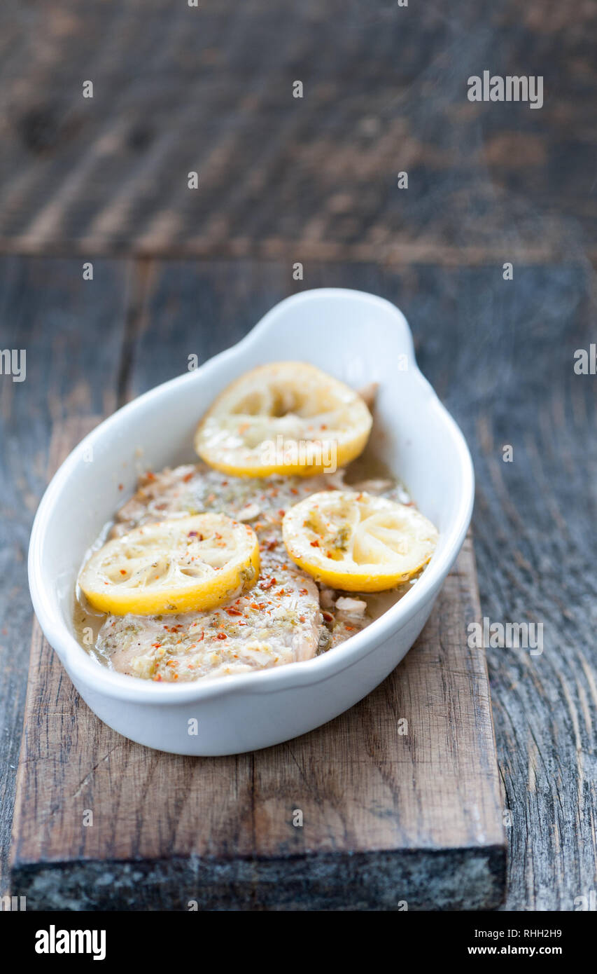 Baked fish fillet in butter and lemon sauce Stock Photo - Alamy