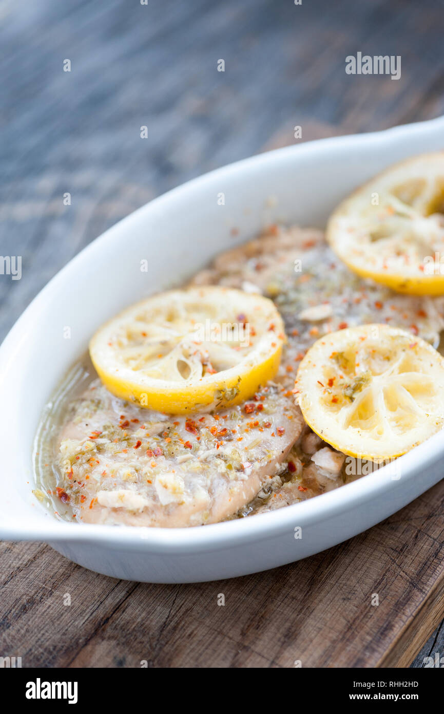 Baked fish fillet in butter and lemon sauce Stock Photo - Alamy