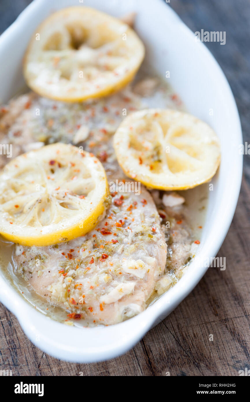 Baked fish fillet in butter and lemon sauce Stock Photo - Alamy