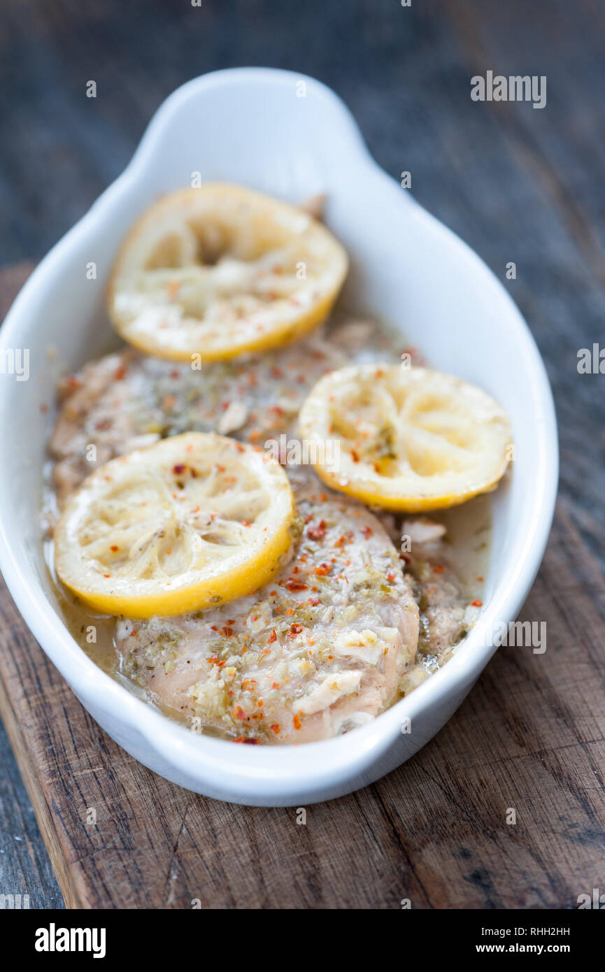 Baked fish fillet in butter and lemon sauce Stock Photo - Alamy