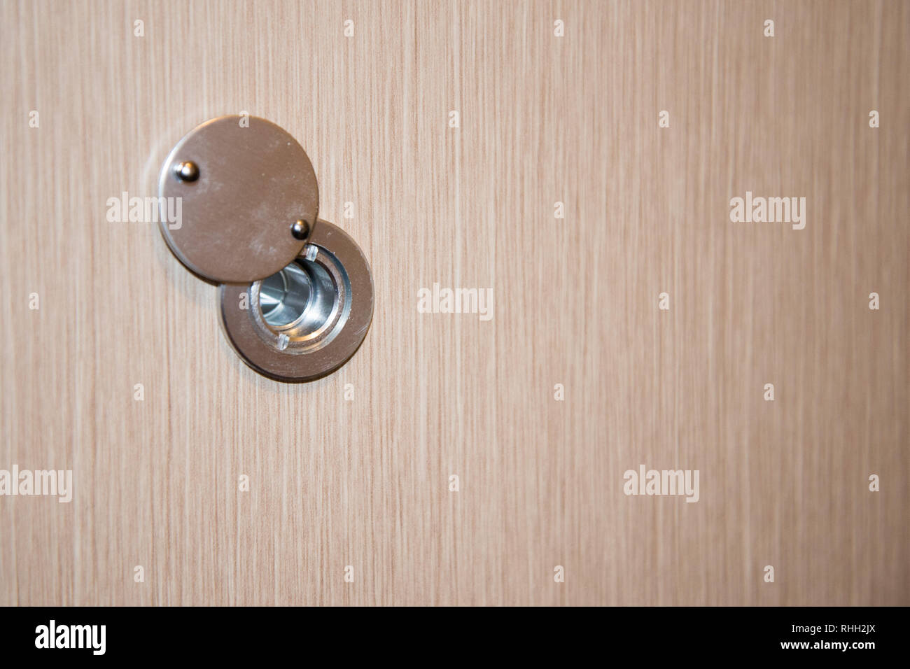 Lens peephole on new light wooden door Stock Photo - Alamy