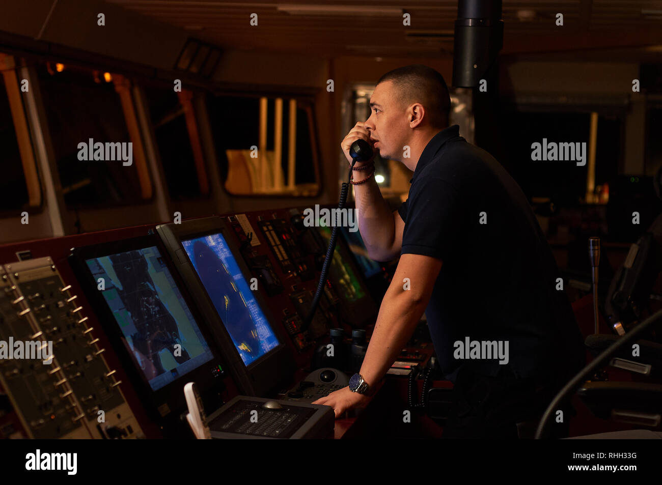 Navigation officer. Pilot on a bridge of a vessel underway with radio ...