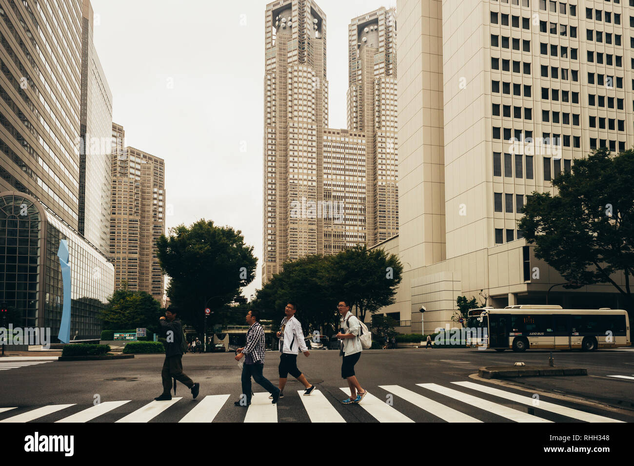 four men crossing the street on a pedestrian crossing, similar to the ...