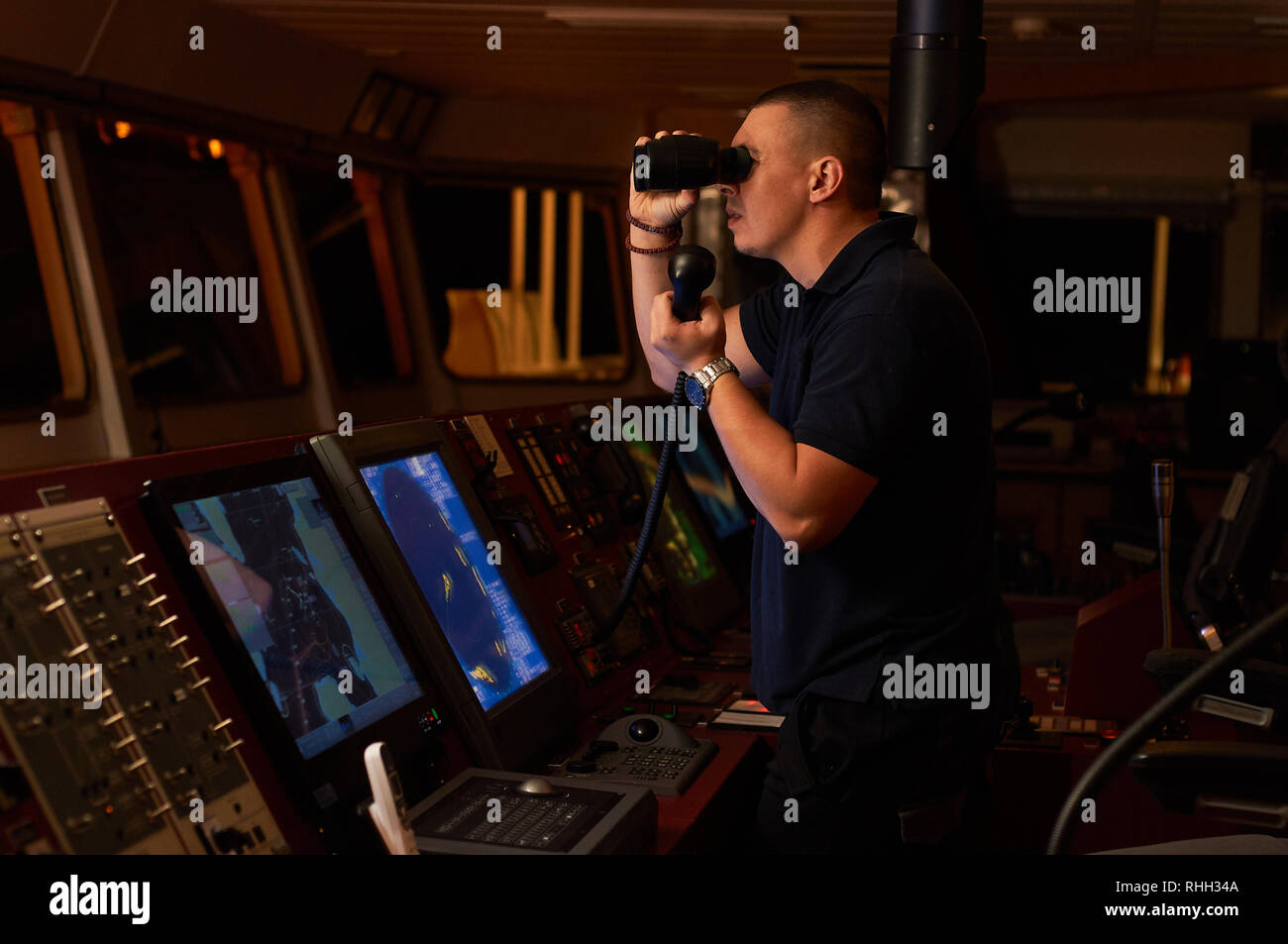 Navigation officer. Pilot on a bridge of a vessel underway with radio ...