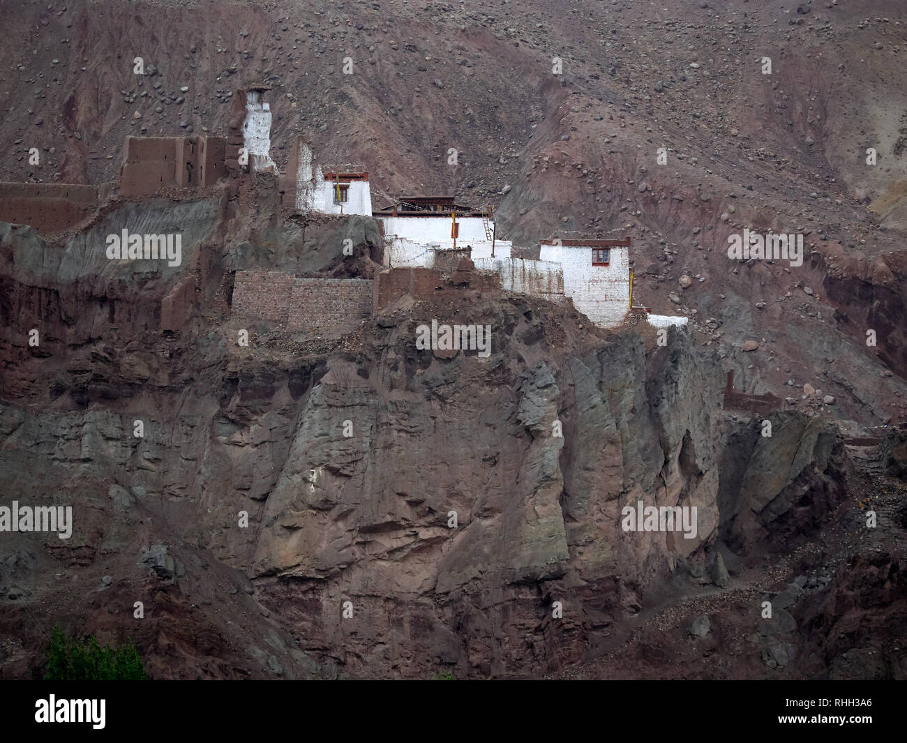 Buddhist monastery of Basgo, ancient white buildings among the burgundy ...