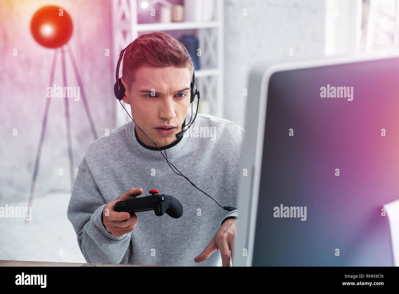 Modern teenager feeling amazing while playing his favorite computer ...