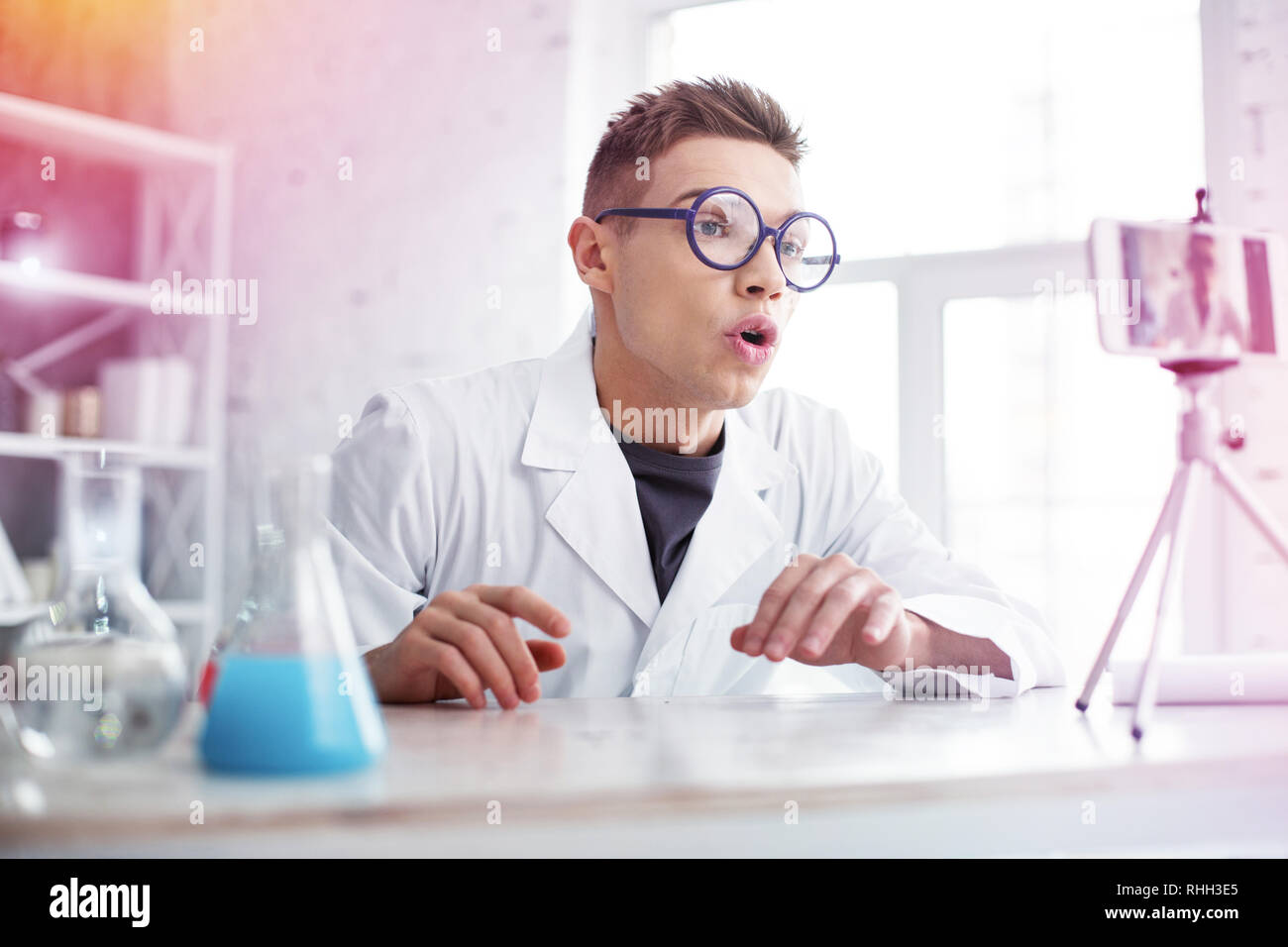 Emotional handsome student feeling surprised after making chemistry ...