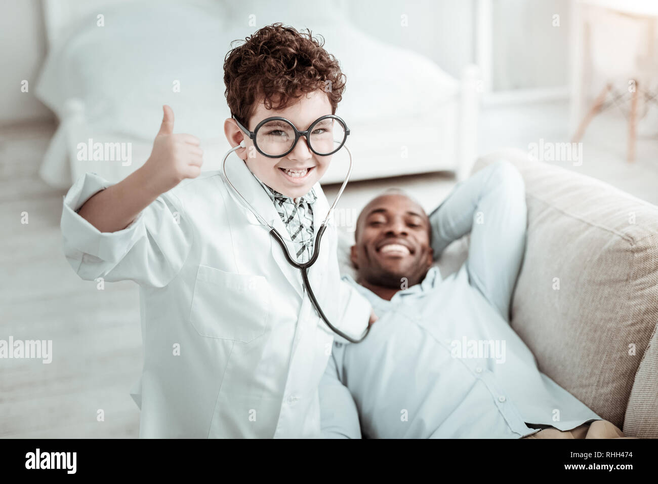 Happy brunette boy raising his thumb up Stock Photo - Alamy