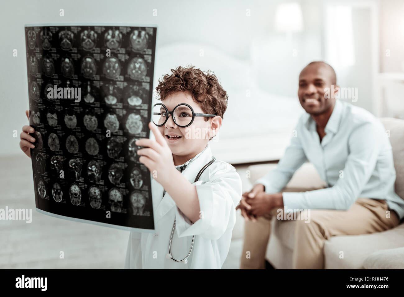 Joyful future practitioner examining an X-ray picture Stock Photo - Alamy