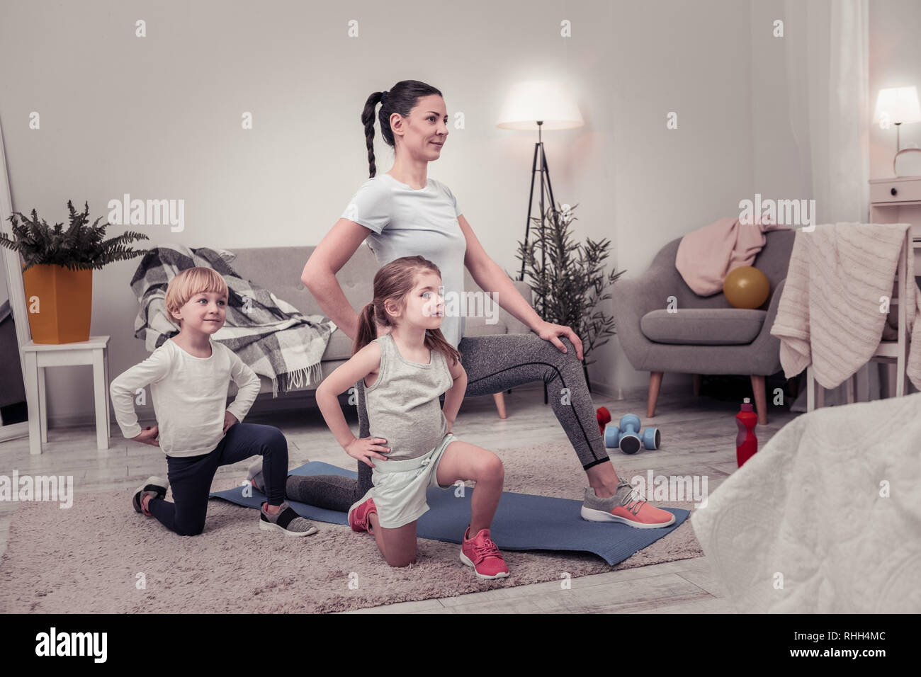 Mother and her children doing exercises together Stock Photo - Alamy