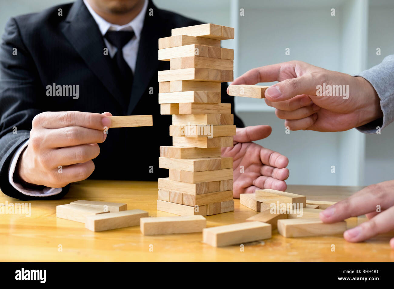 Businessmen picking domino blocks to fill the missing dominos and ...