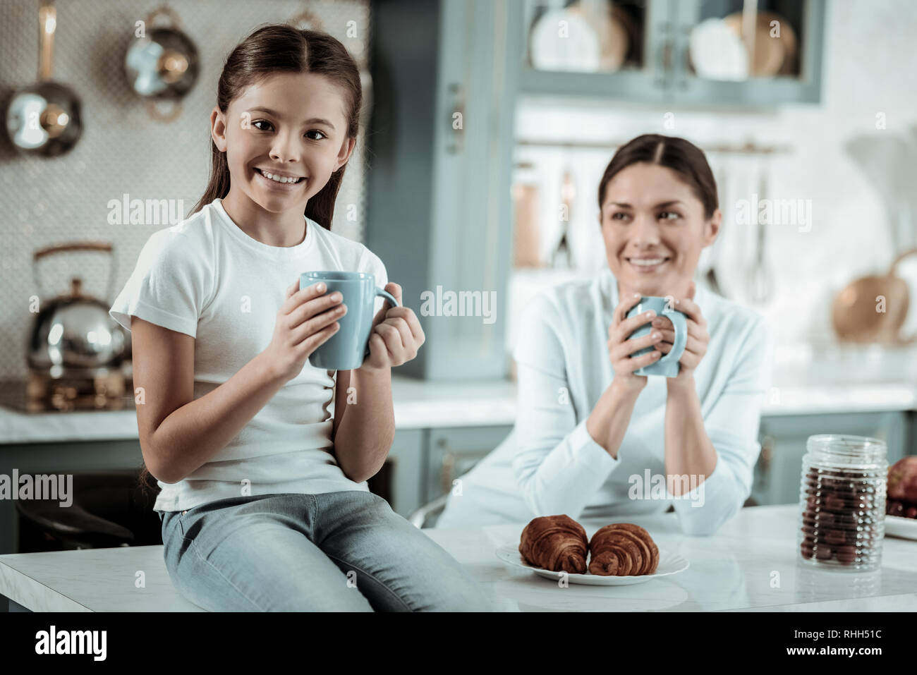 Mother and daugther drinking tea together in the kitchen Stock Photo ...