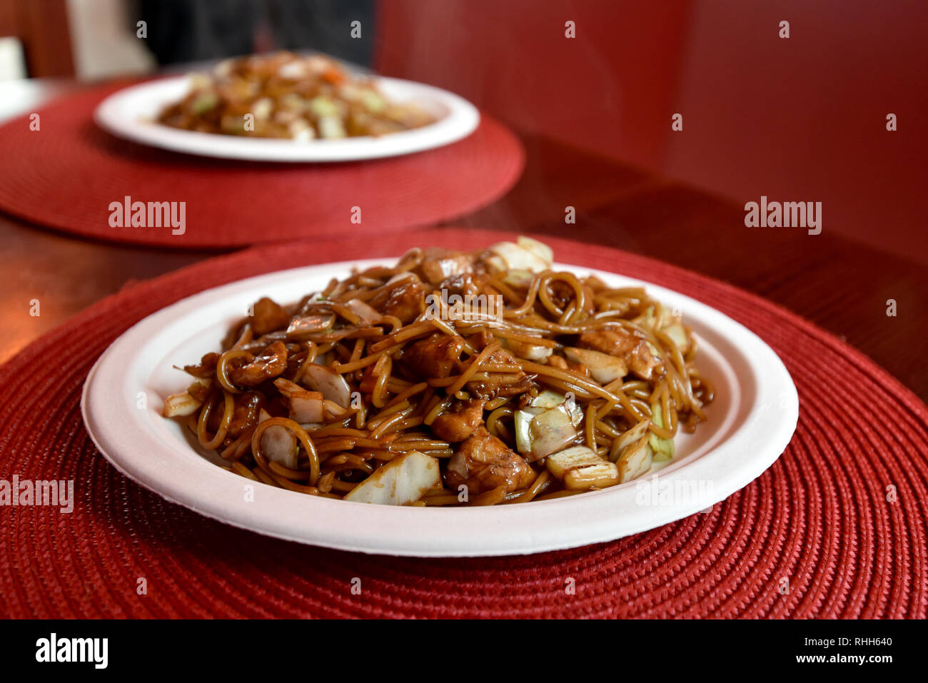 Asian noodles with vegetables and chicken served on plate Stock Photo ...