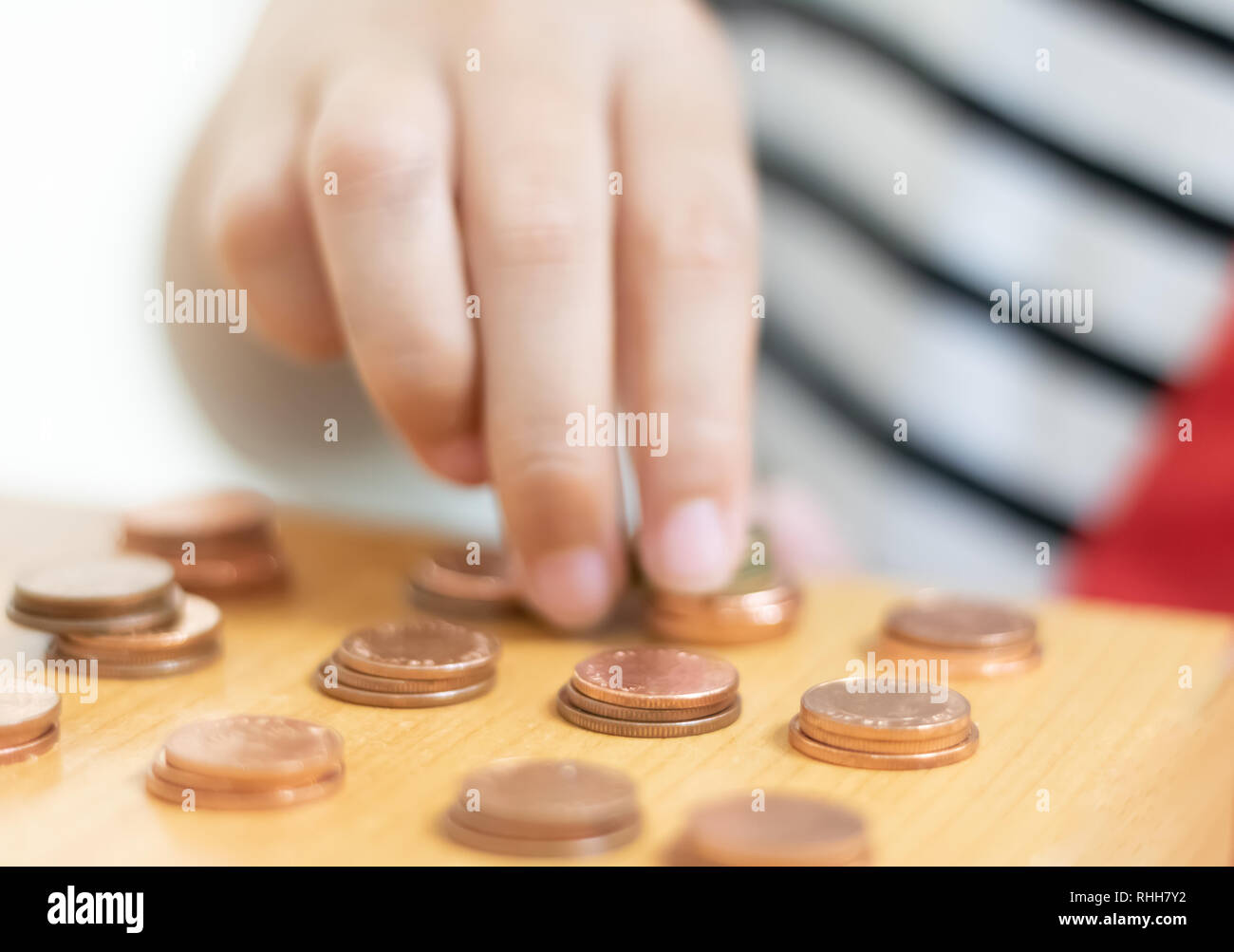 Hand and coin stacking Stock Photo - Alamy