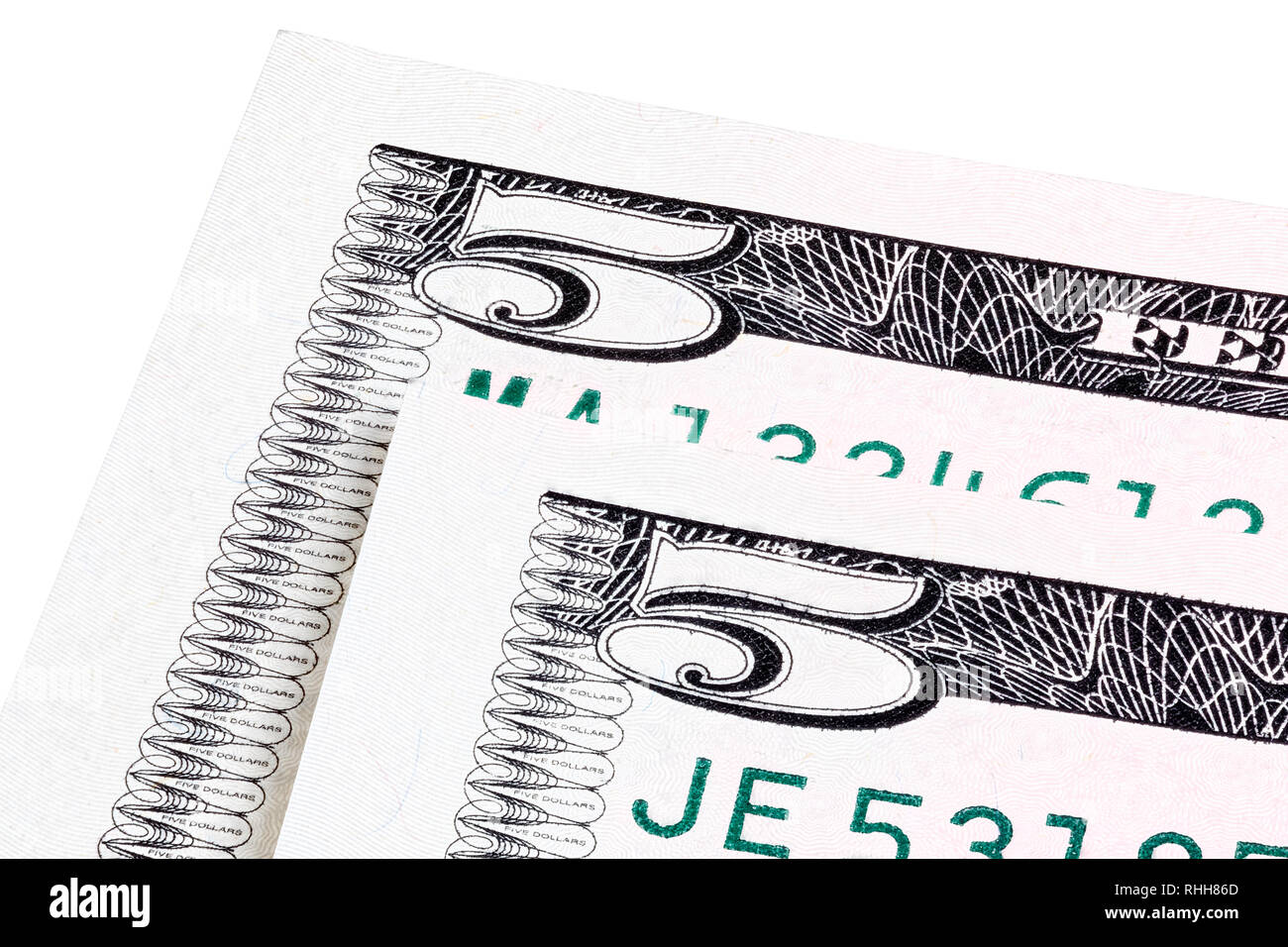Detail photo of two U.S. five dollar bill, isolated on white, stacked ...