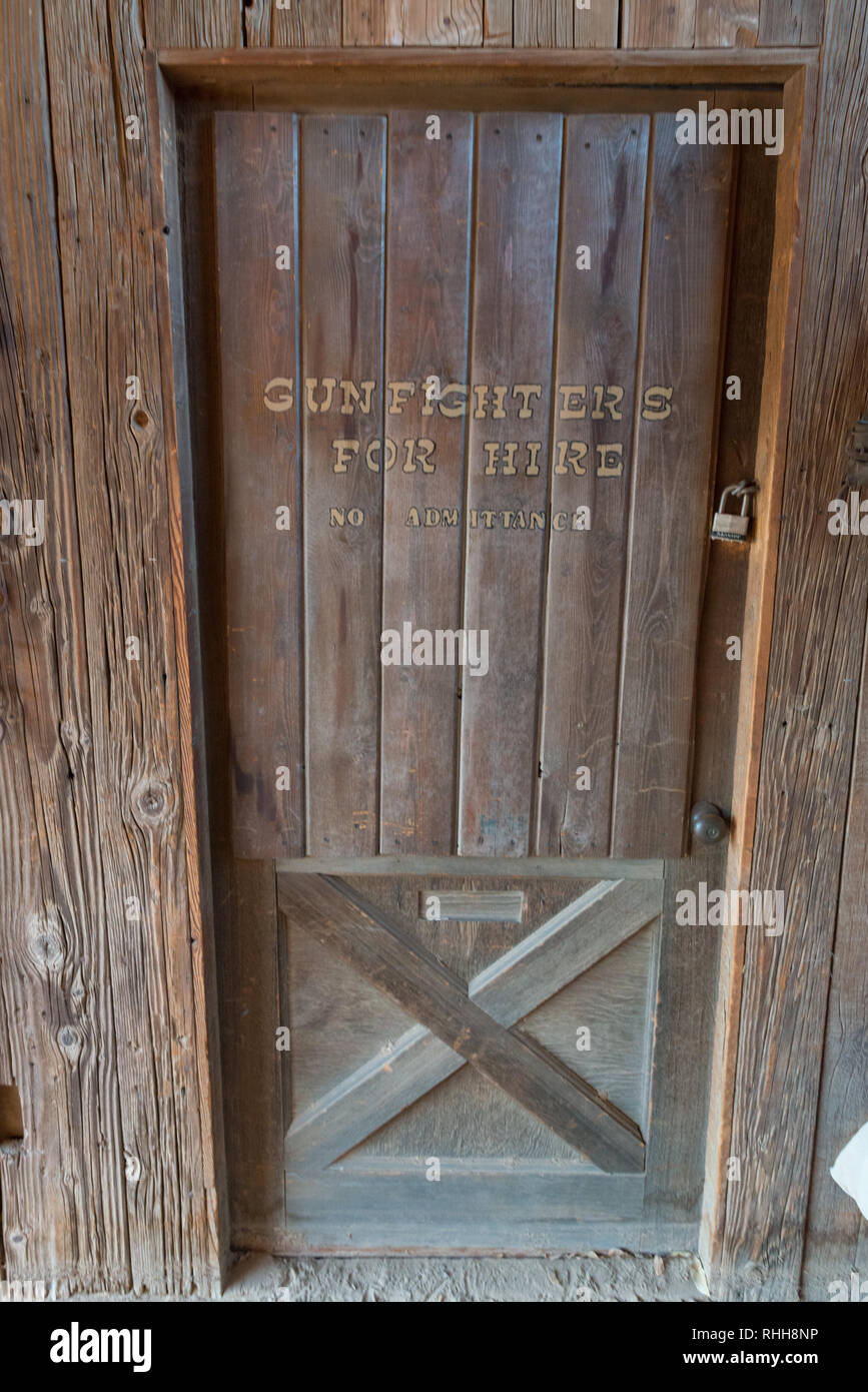 Pioneertown gunfighters for hire sign on closed door in California, USA ...