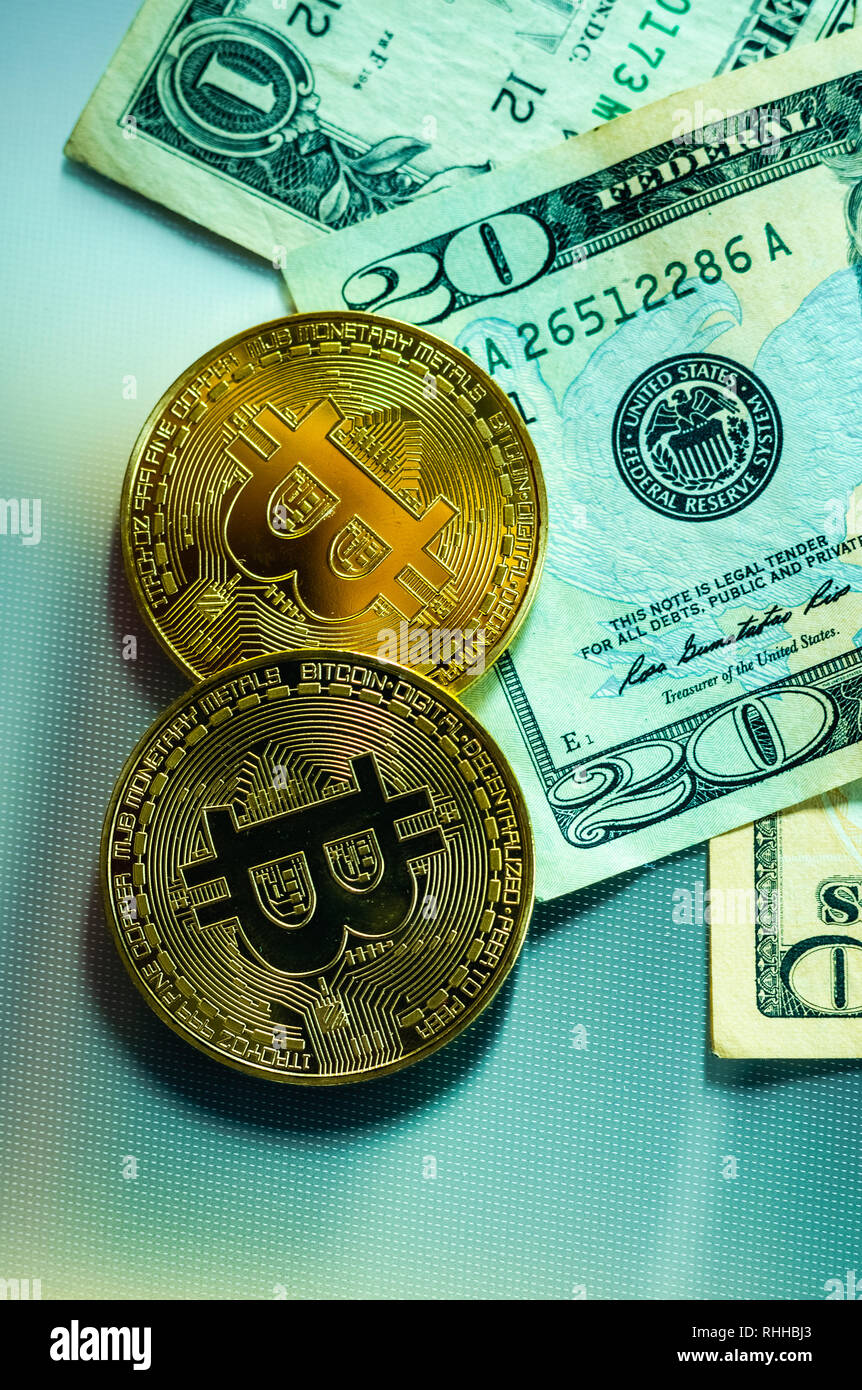 Dollar bills in front of two bitcoin coins, traditional versus new ...