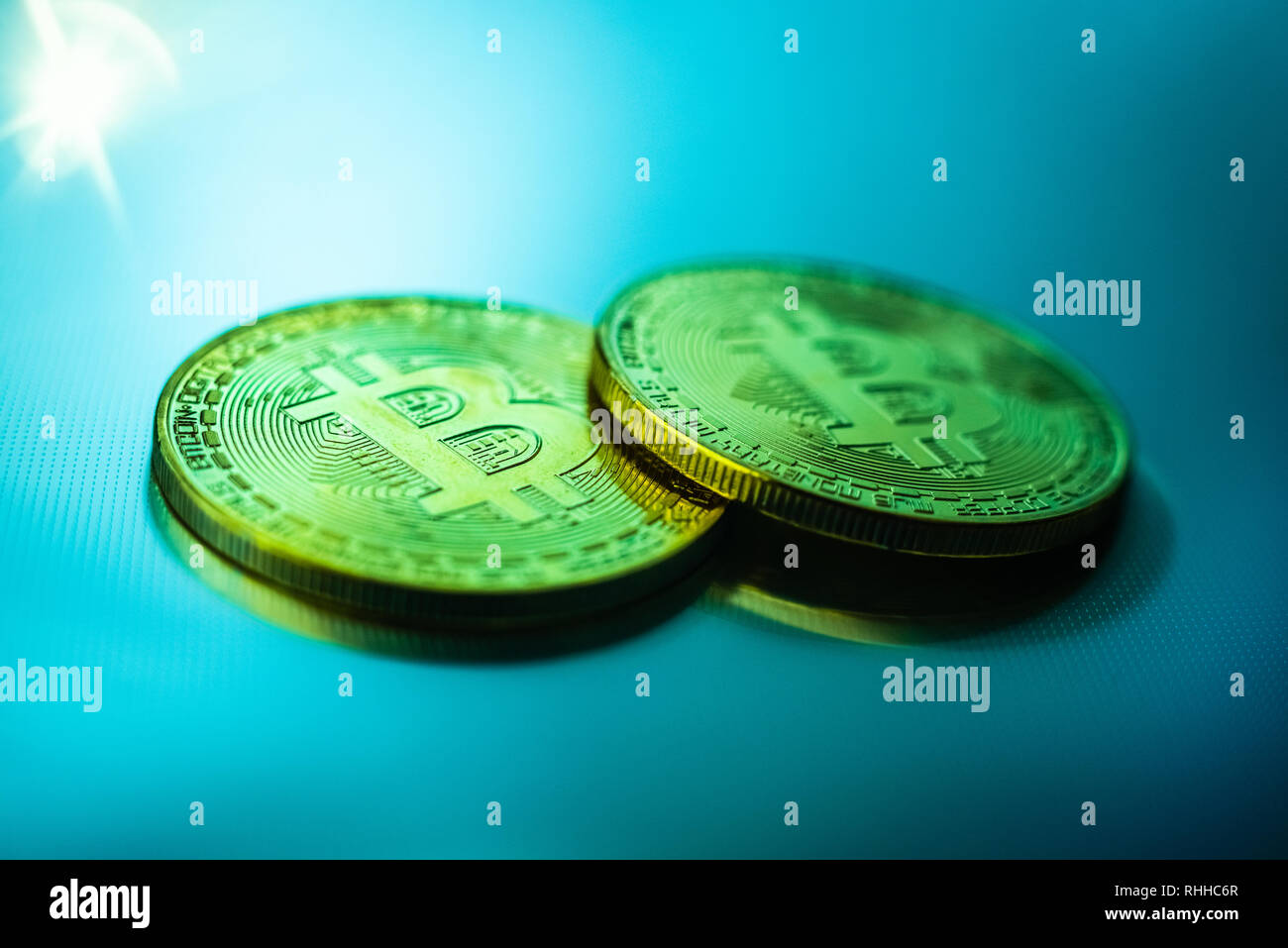 Two bitcoin coins isolated on technological blue background Stock Photo ...