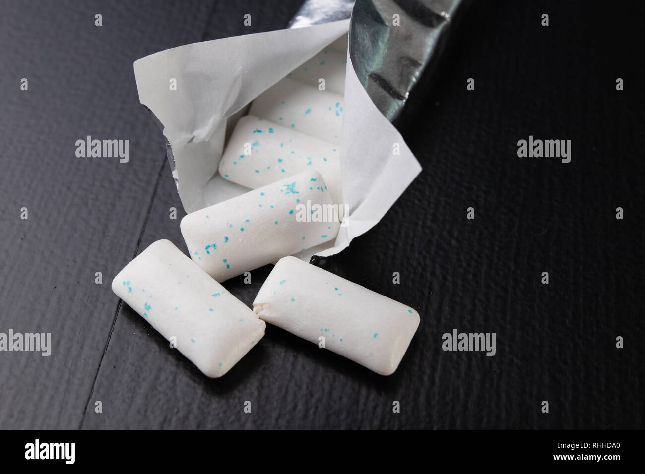 Chewing gum on the table. Mint refreshing tablet in a silver package ...