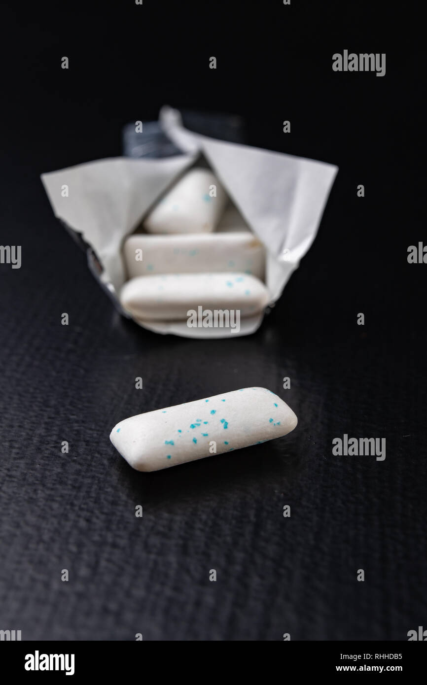 Chewing gum on the table. Mint refreshing tablet in a silver package ...