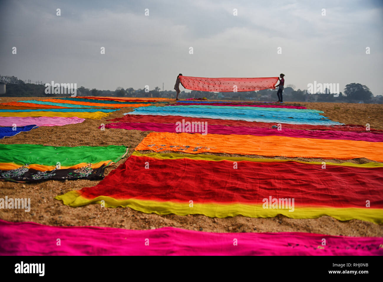 Dhobis (washermen) seen spreading the clothes on the soil next to the ...