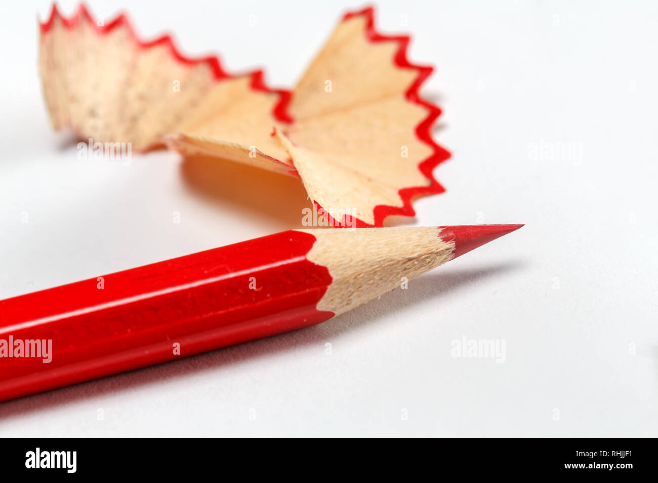 Red sharpened pencil close-up on a white background Stock Photo - Alamy