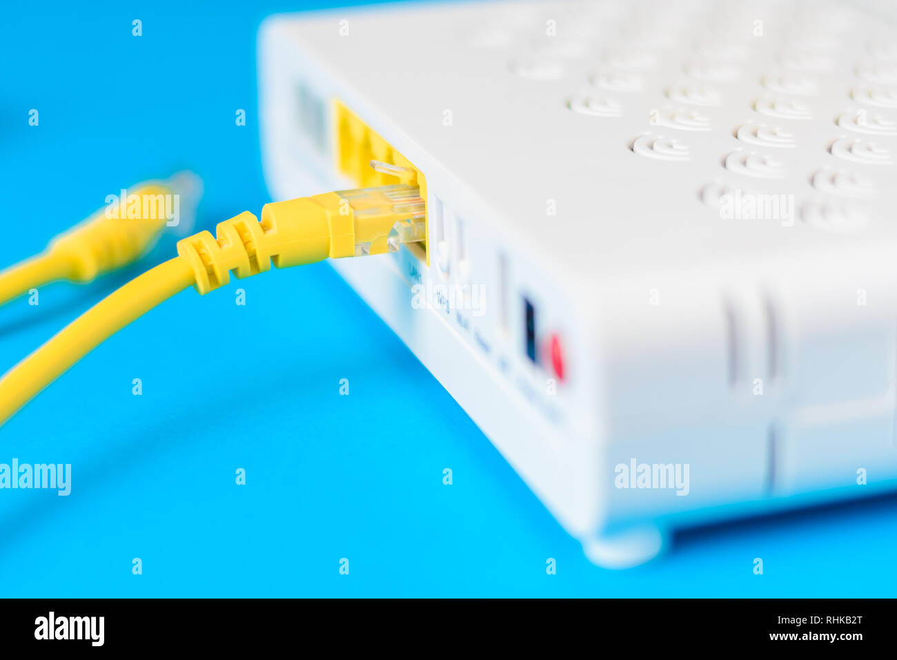 home wireless router with ethernet cable plugged in on blue background ...