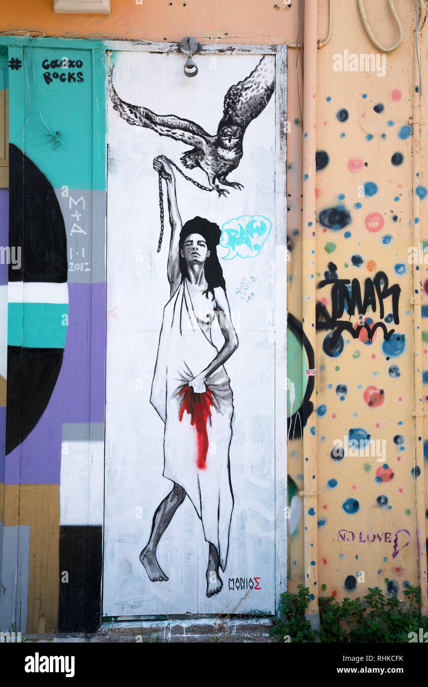 Street art depicting Athena in a blood stained rob with a chained owl ...