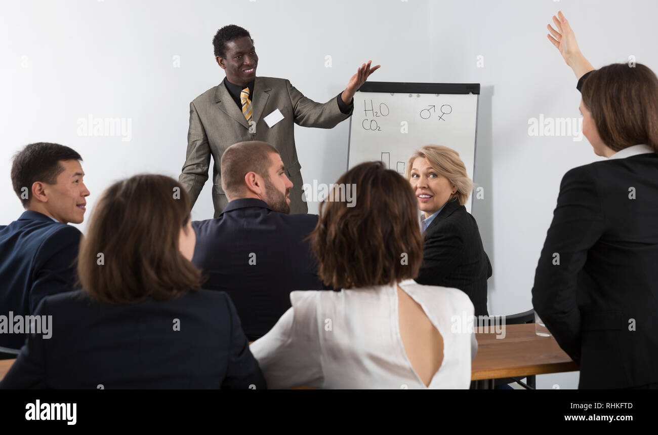 Positive African American business coach communicating with group ...