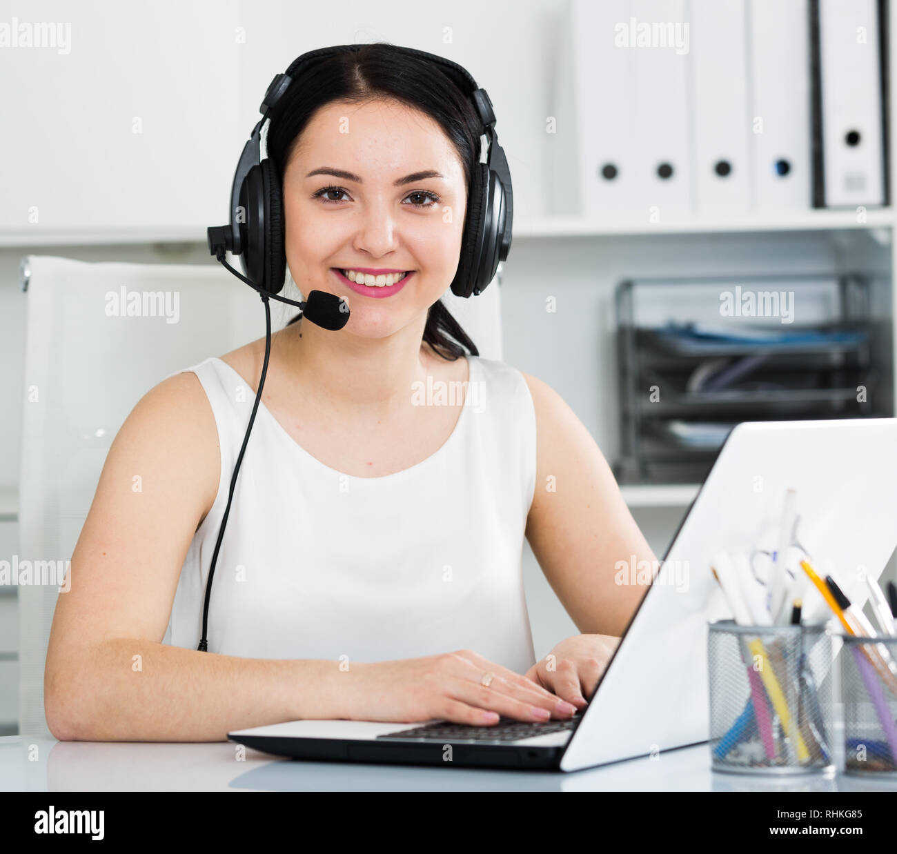 Young woman worker productively operating at call-center Stock Photo ...
