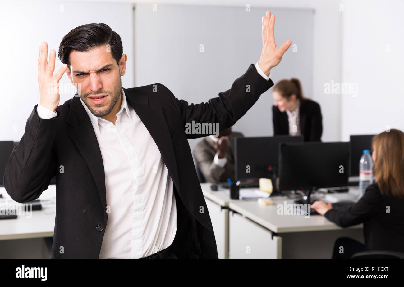 Angry manager standing in office dissatisfied with teamwork of ...