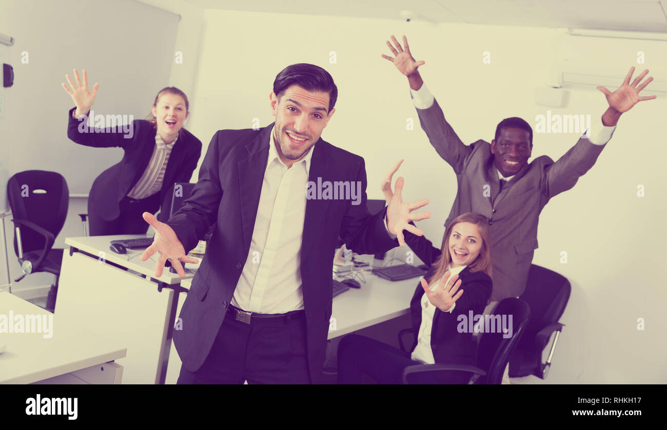 Satisfied multinational business team expressing satisfaction with ...