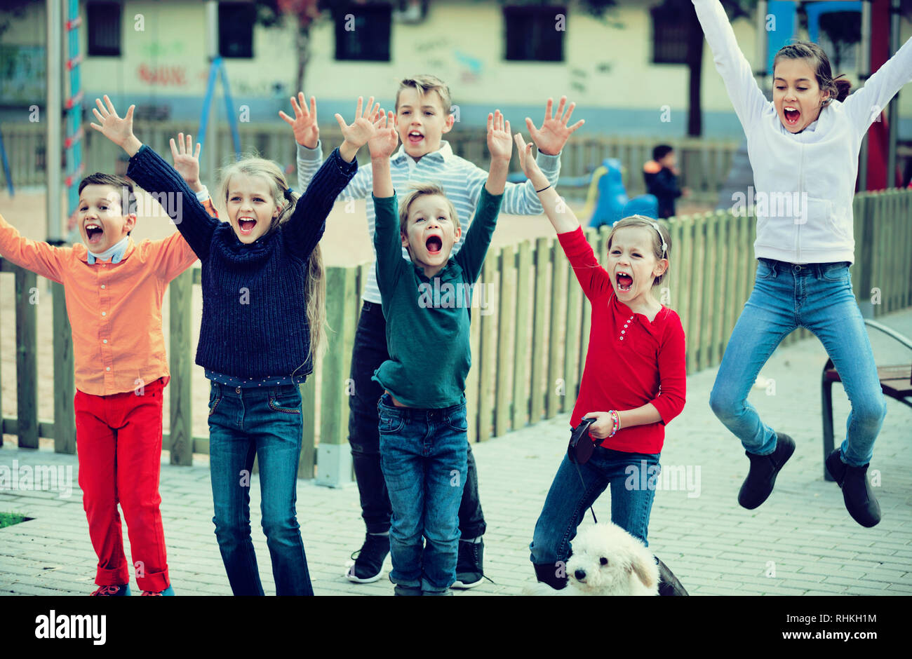 Happy cheerful laughing kids having fun and jumping up Stock Photo - Alamy
