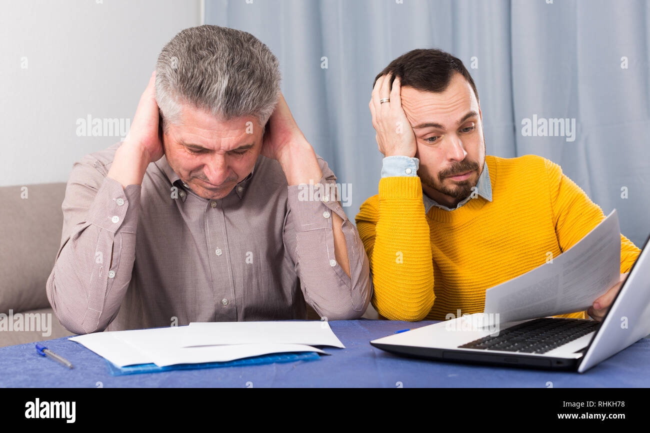 Son and father signing documents hi-res stock photography and images ...
