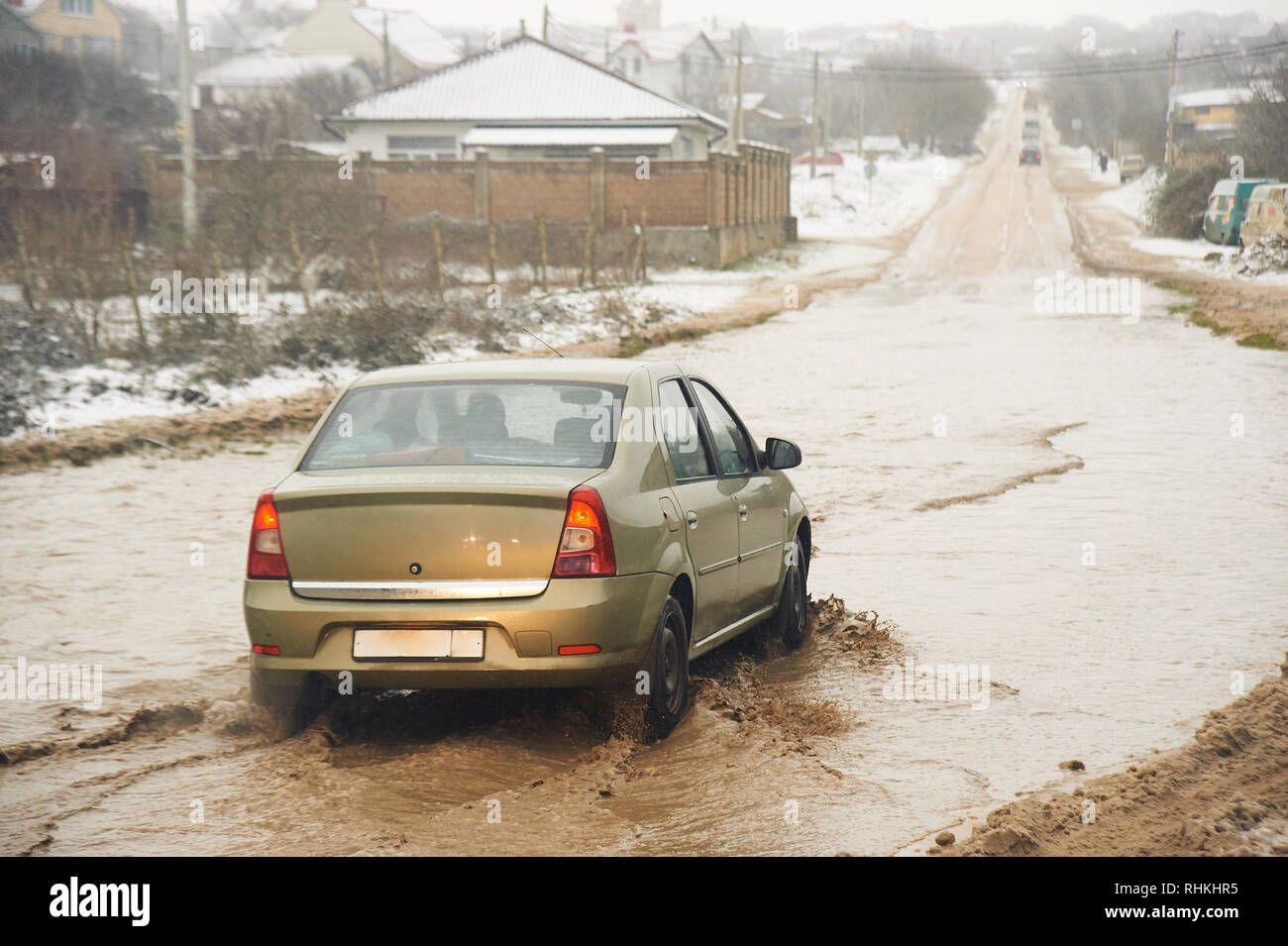 car goes by broken dirty road. bad roads condition problem concept ...