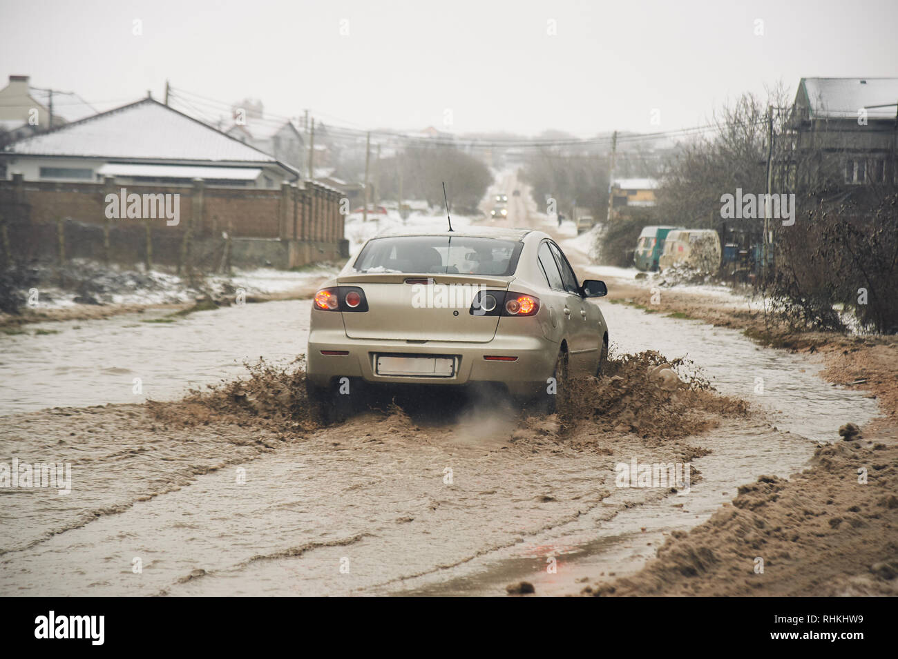 car goes by broken dirty road. bad roads condition problem concept ...