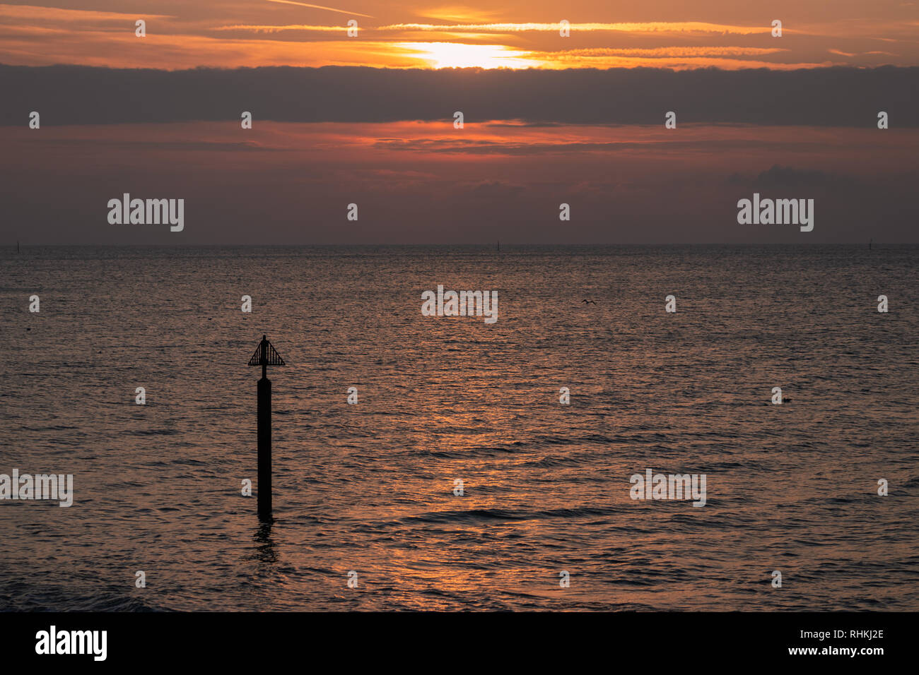 beach marker at sunset Stock Photo - Alamy