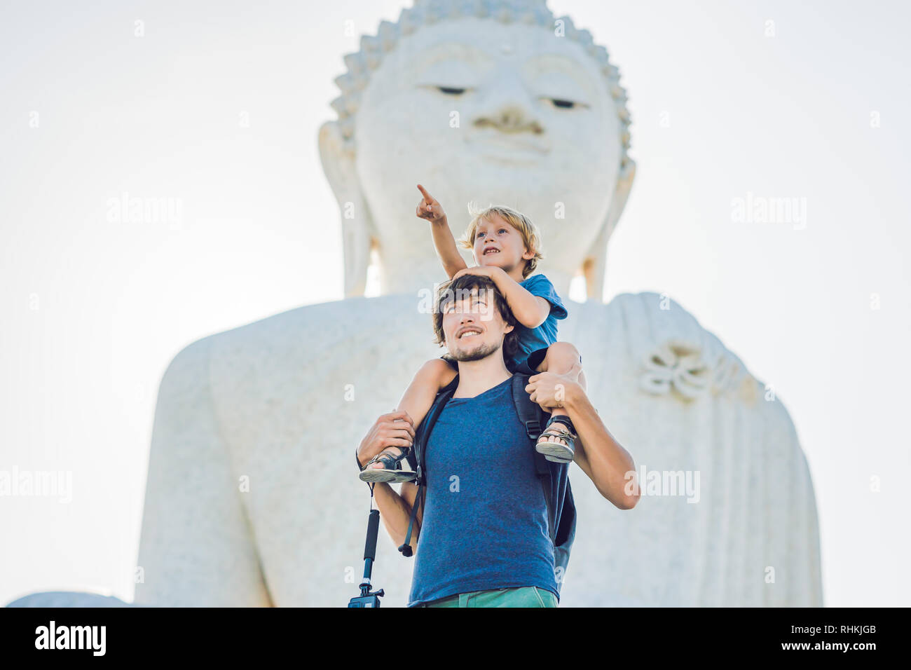 Father and son tourists on the Big Buddha statue. Was built on a high ...