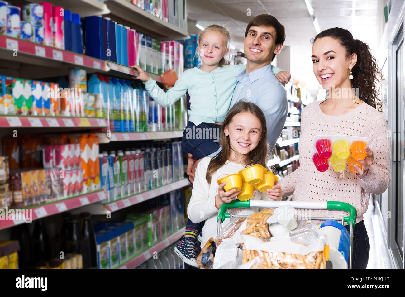 Ordinary european customers with children selecting sweet dairy ...