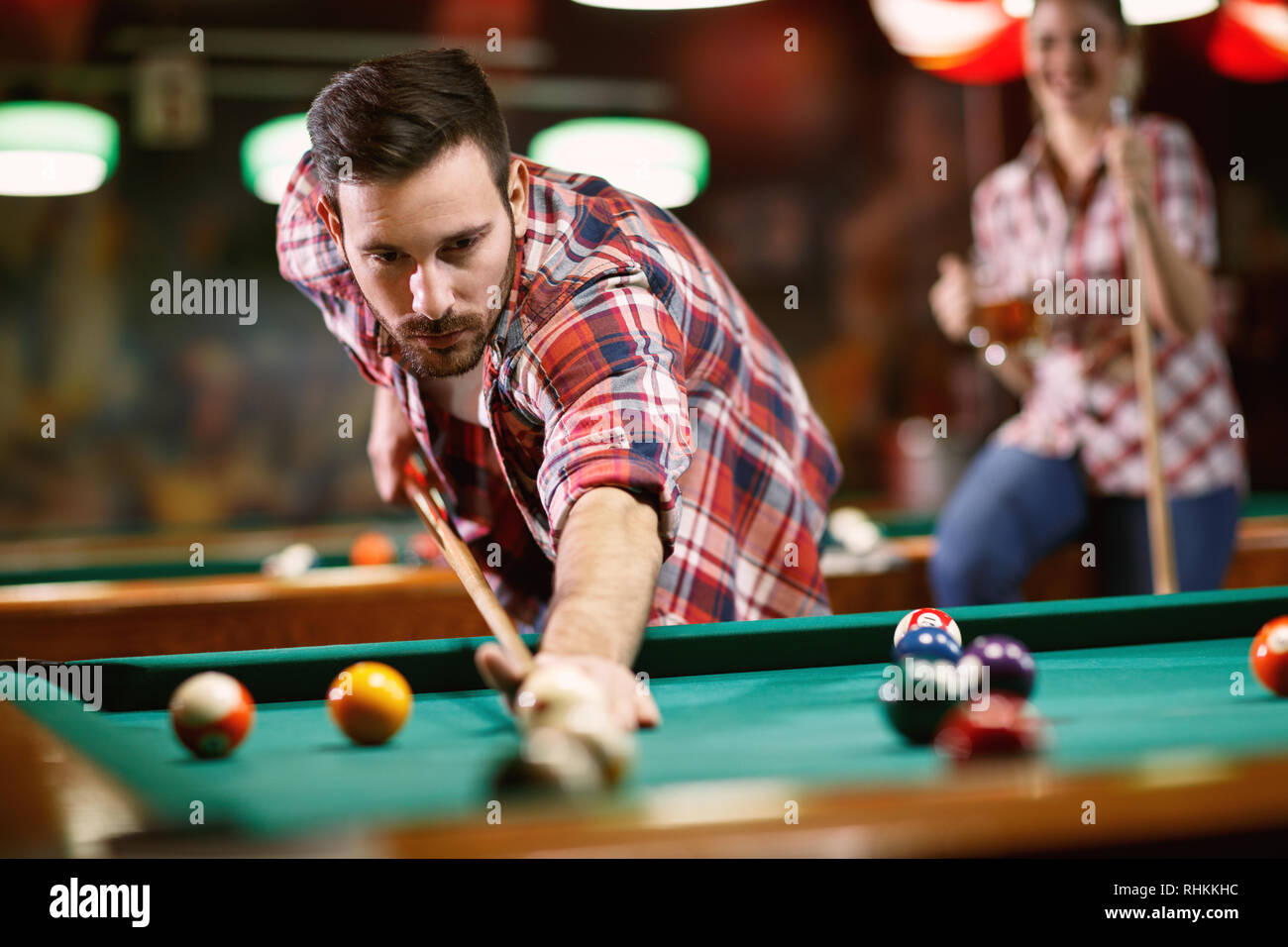 Young man standing at pool table hi-res stock photography and images ...