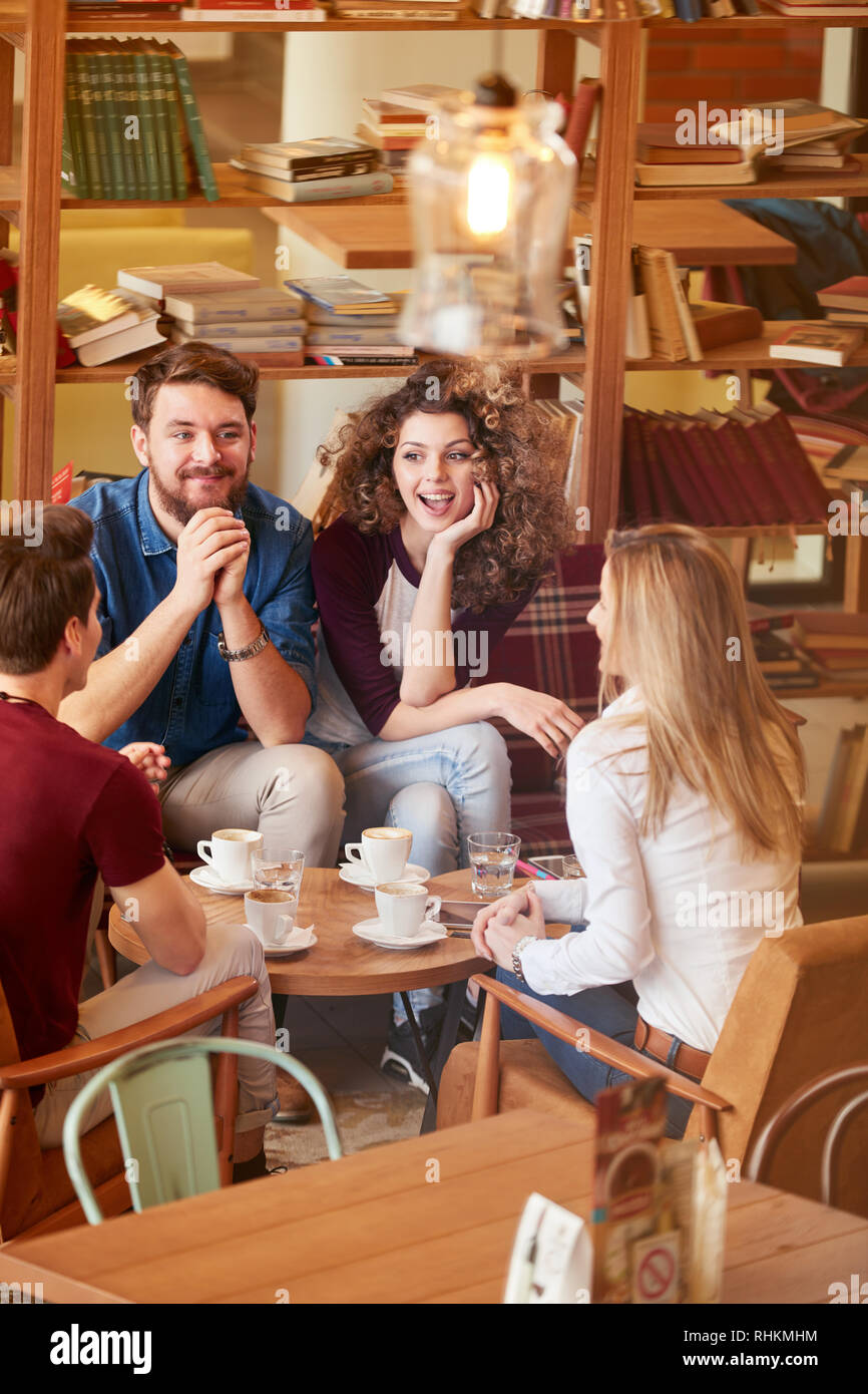 Two young couple together talking in cafe Stock Photo - Alamy