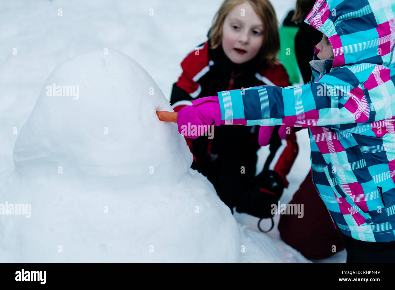 kids making a snowman Stock Photo - Alamy