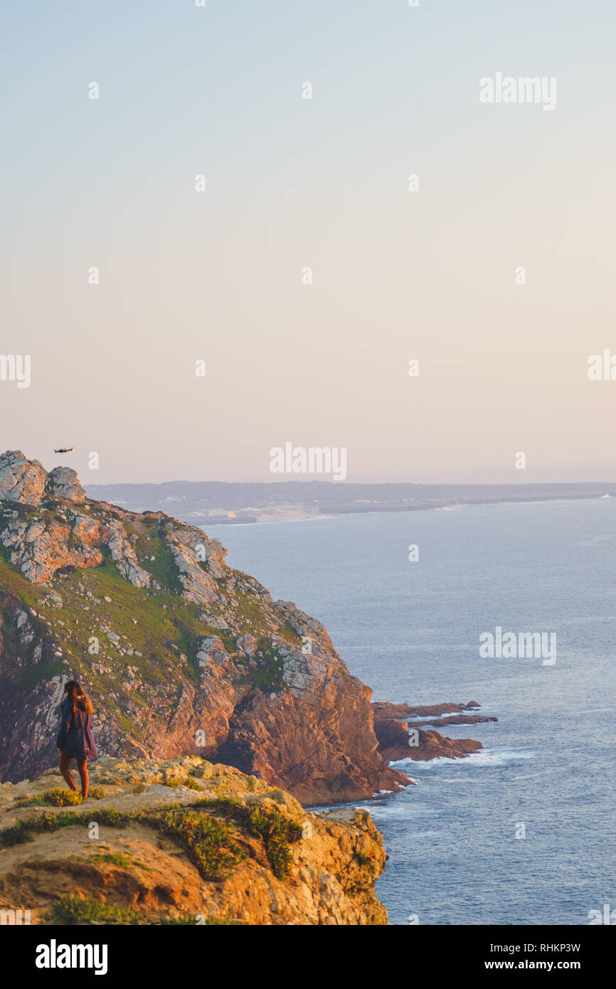 Anonymous person standing at the edge of europe at sunset, Cape roca ...
